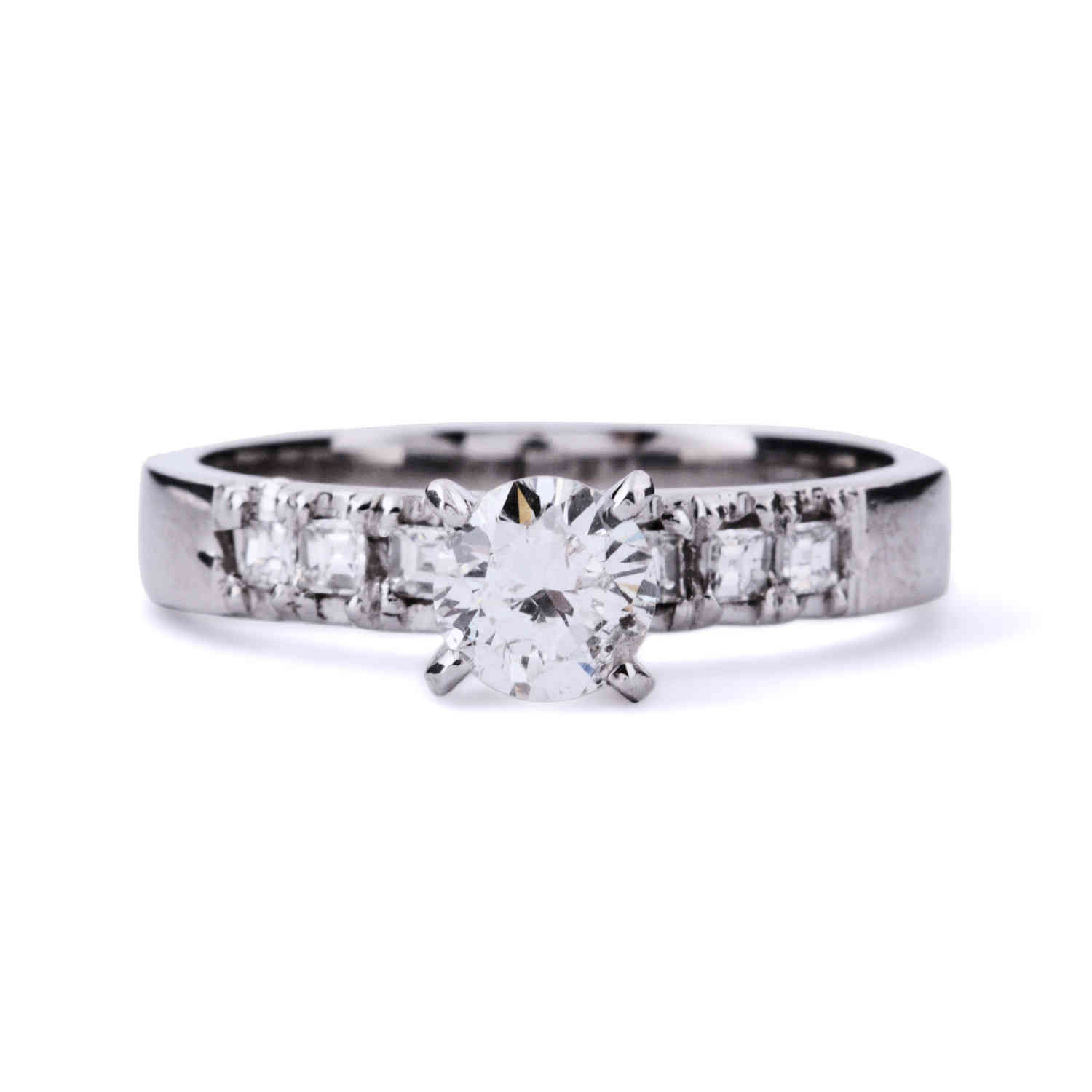 A diamond solitaire ring - The round brilliant center stone is flanked ...