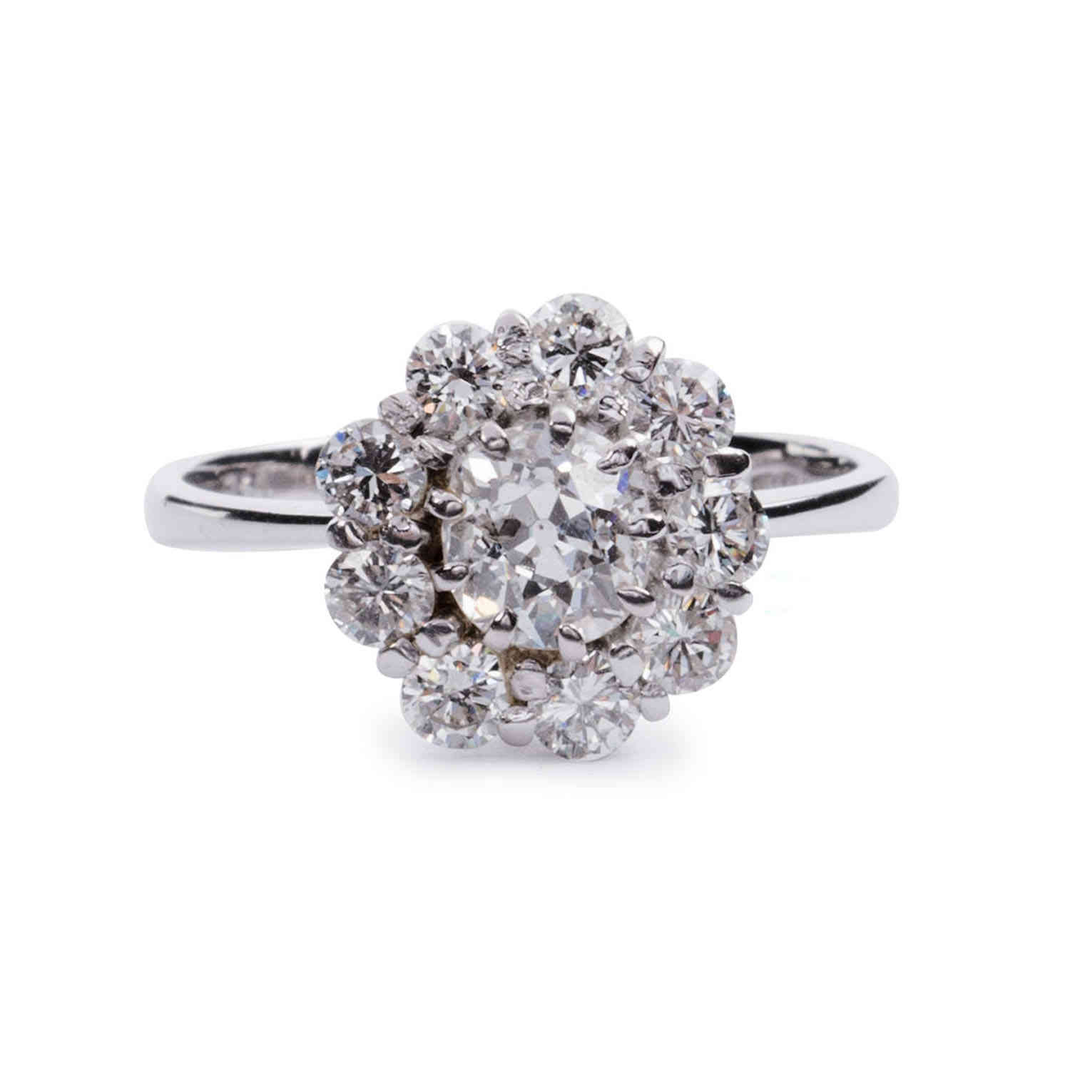 A scintillating floral cluster diamond ring, miner's cut center stone ...