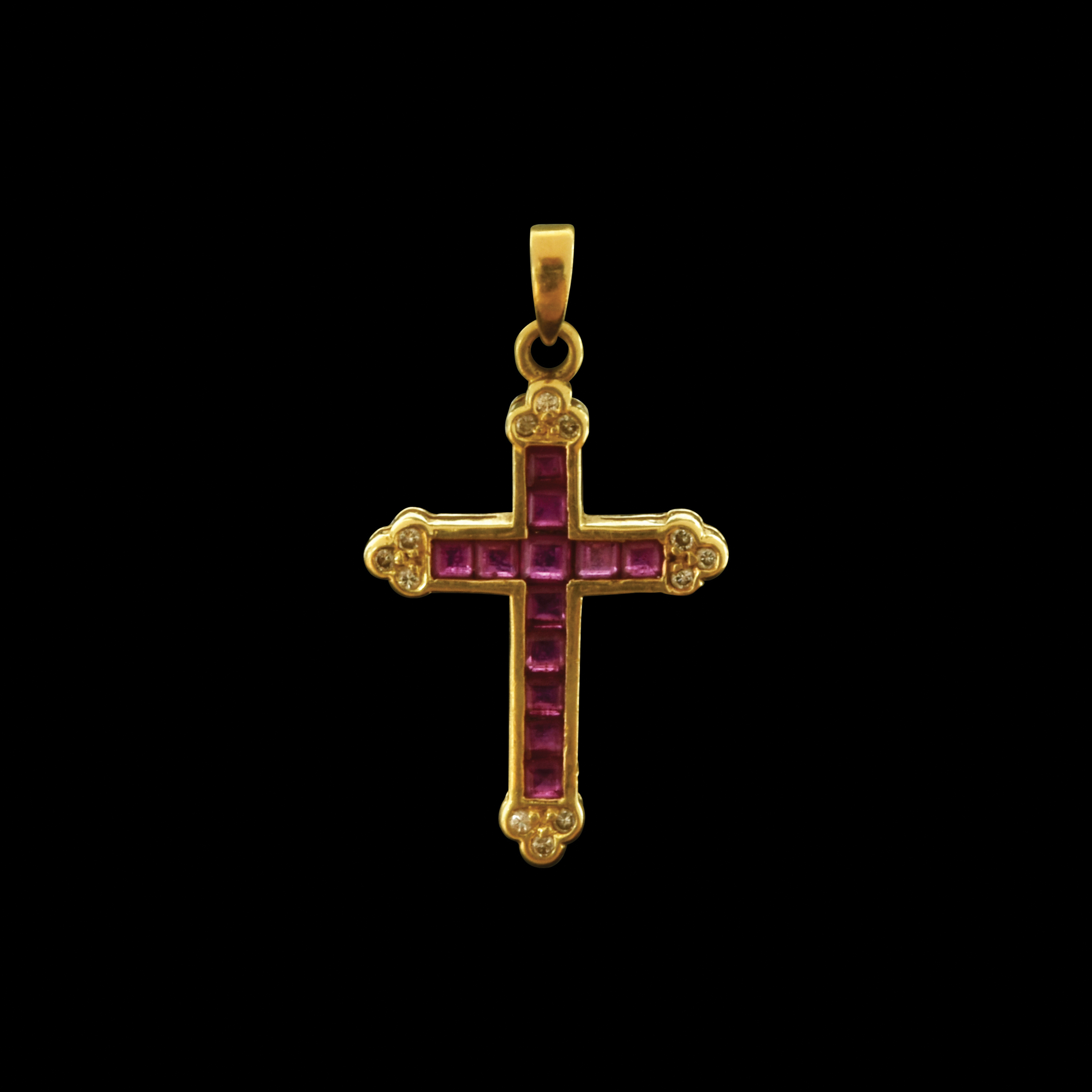 - A ruby cross set in 18k yellow gold