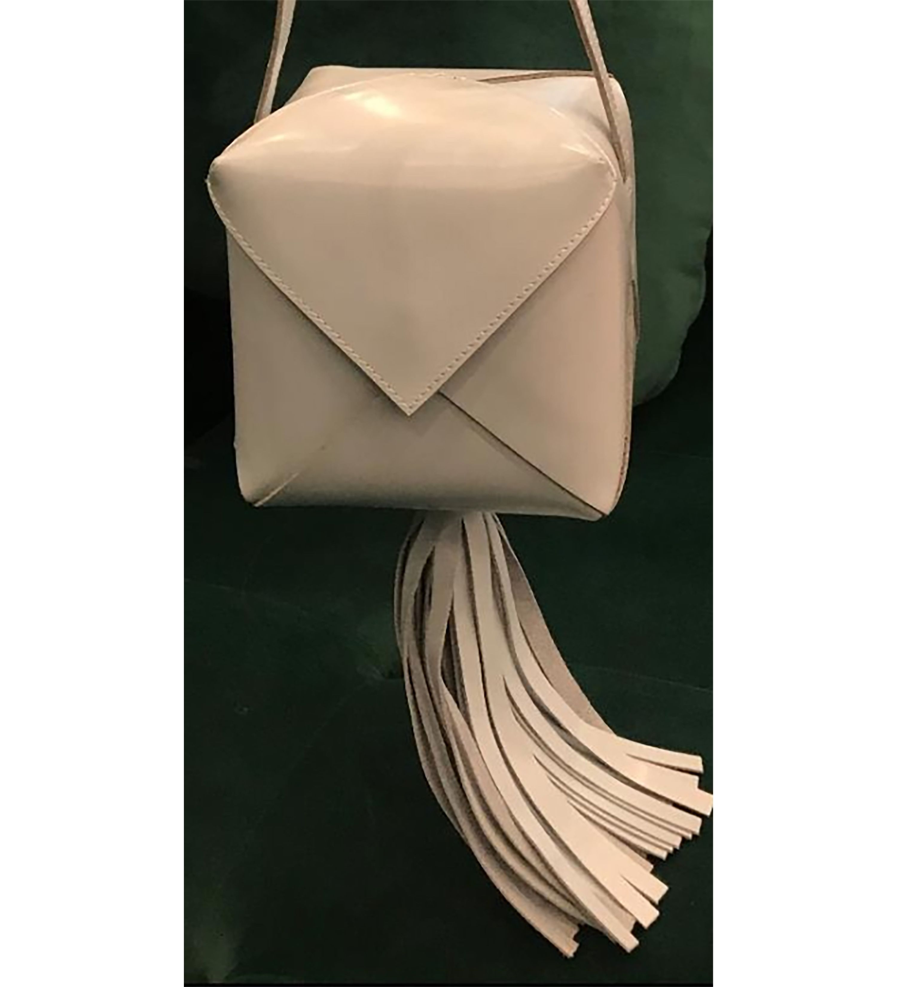 FINO - A beige 'sipa' sling bag in crocodile embossed Italian leather