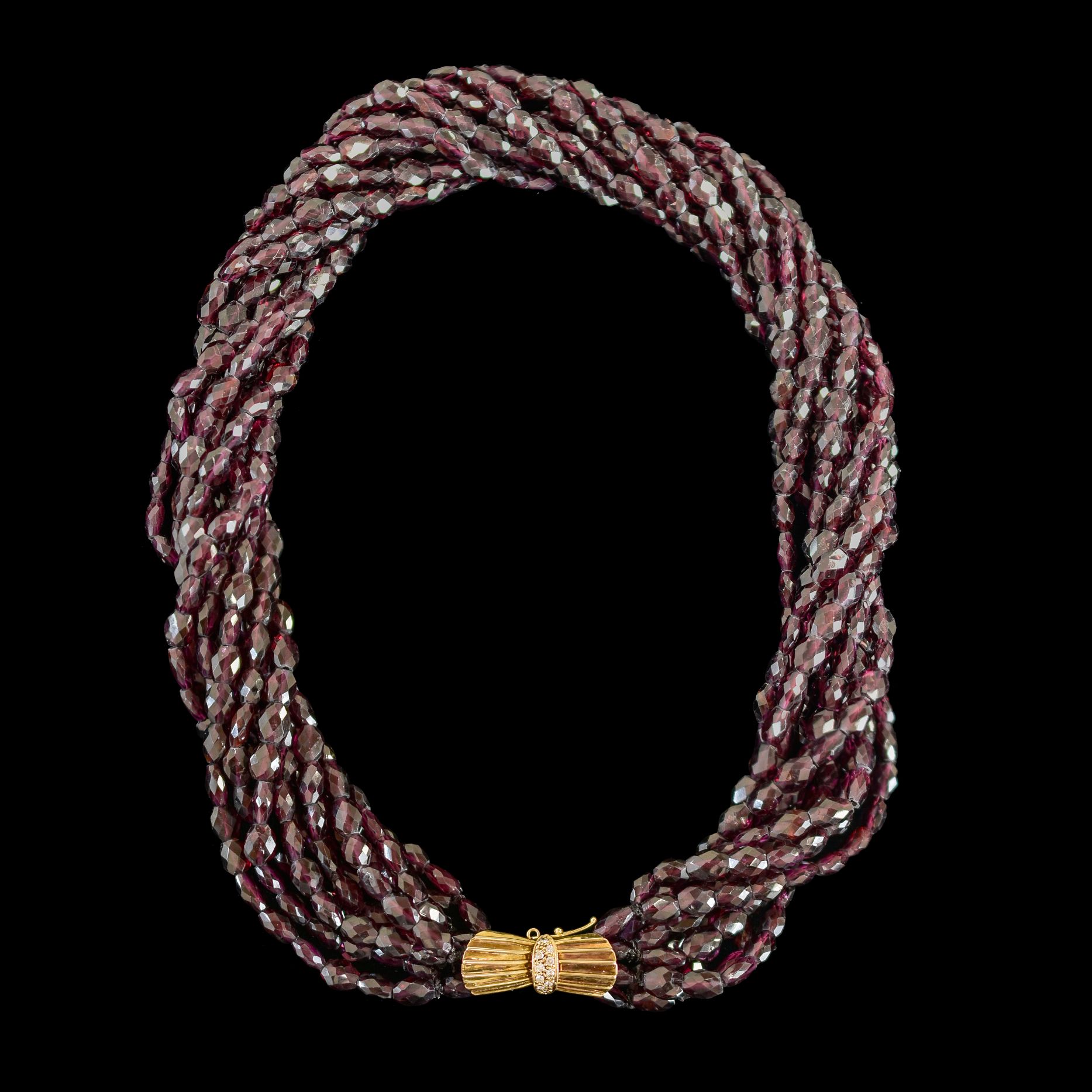 - A multi-strand faceted garnet necklace with 18k gold ribbon clasp