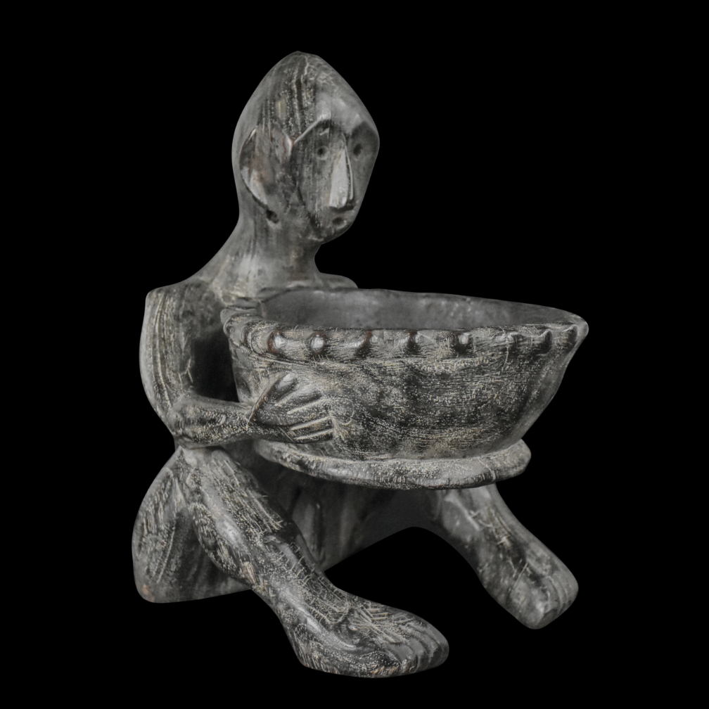 - A small figure holding bowl
