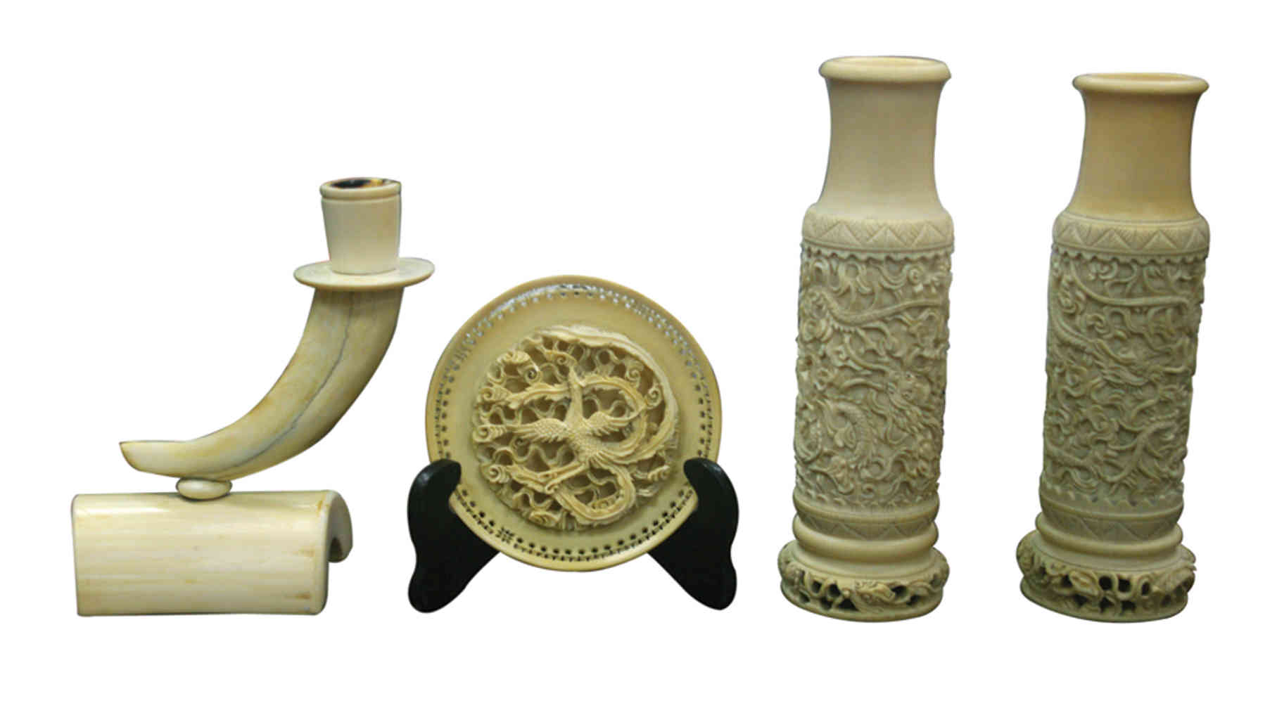 A lot of ivory items consisting of a candle holder, a decorative plate ...