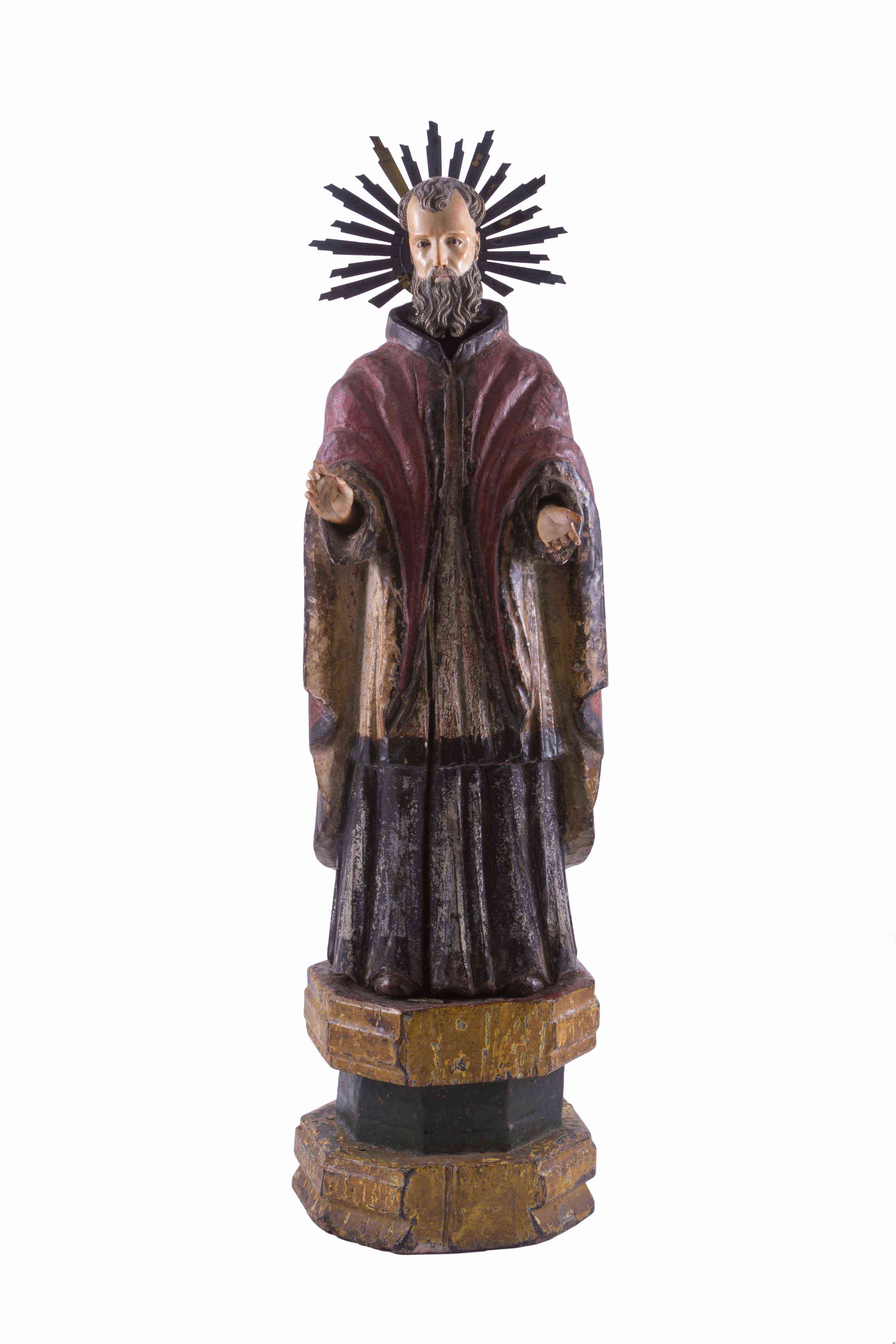 A figurine of a male saint with ivory head and hands