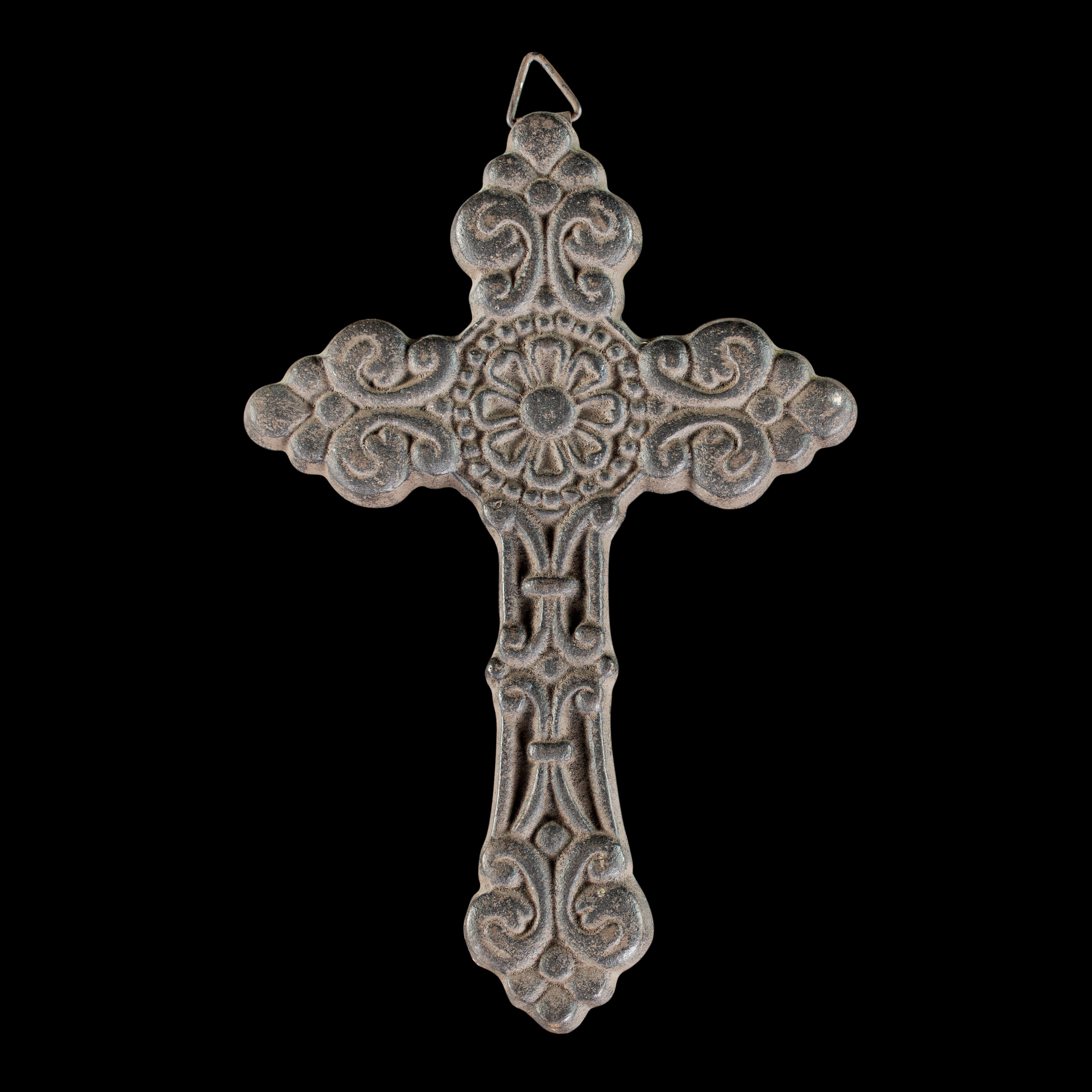 - An ornate iron wall budded cross
