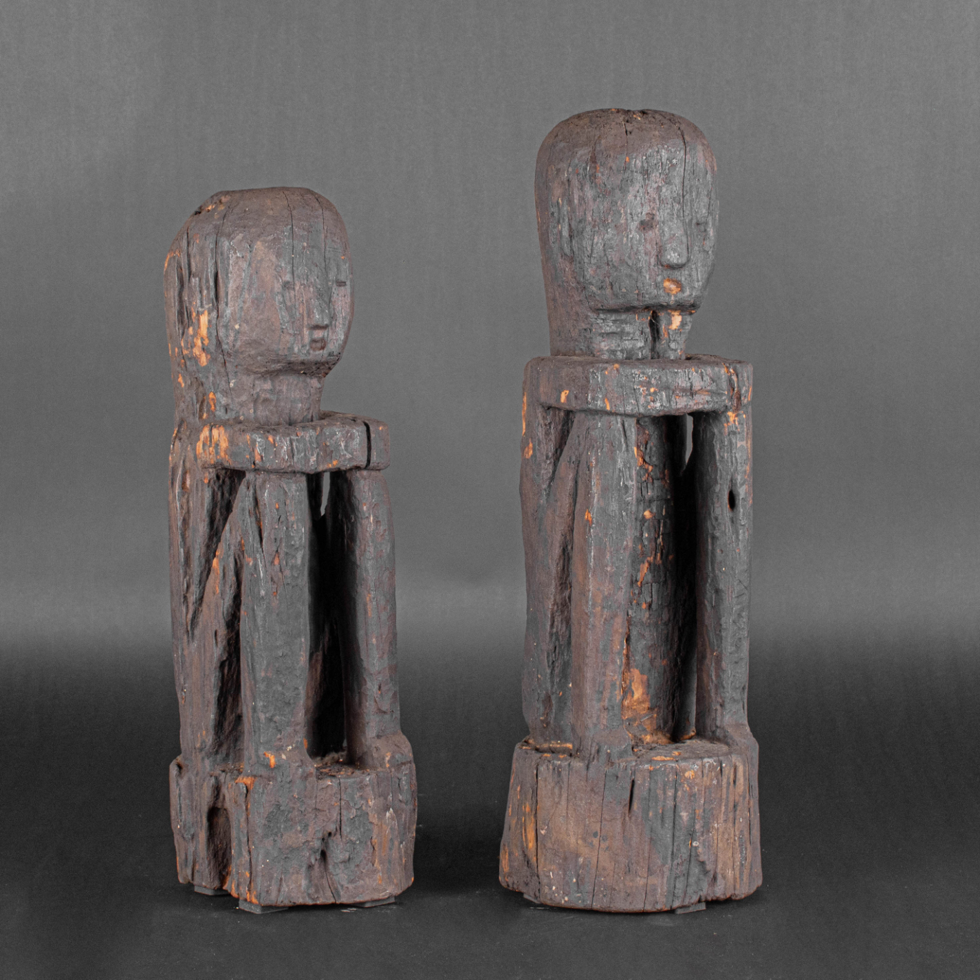 - A pair of seated male/female bulul with arms resting on the knees