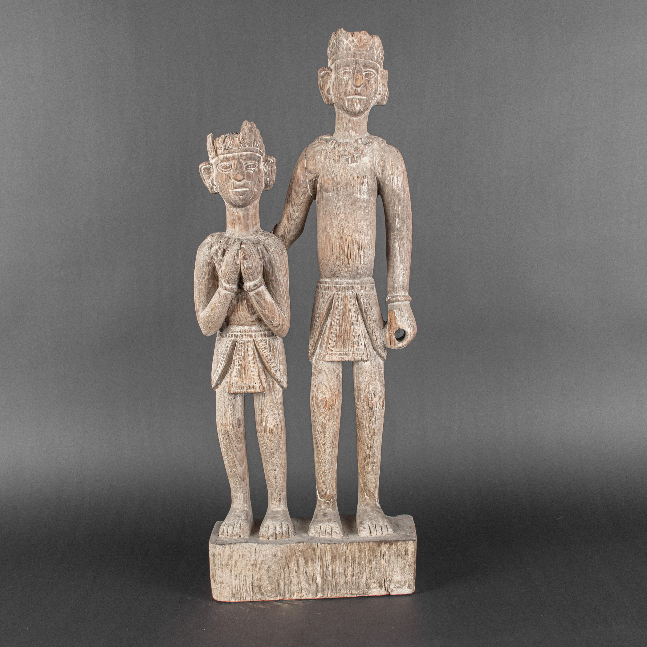 - A standing father and son wood carved spirit post effigies beside a ...