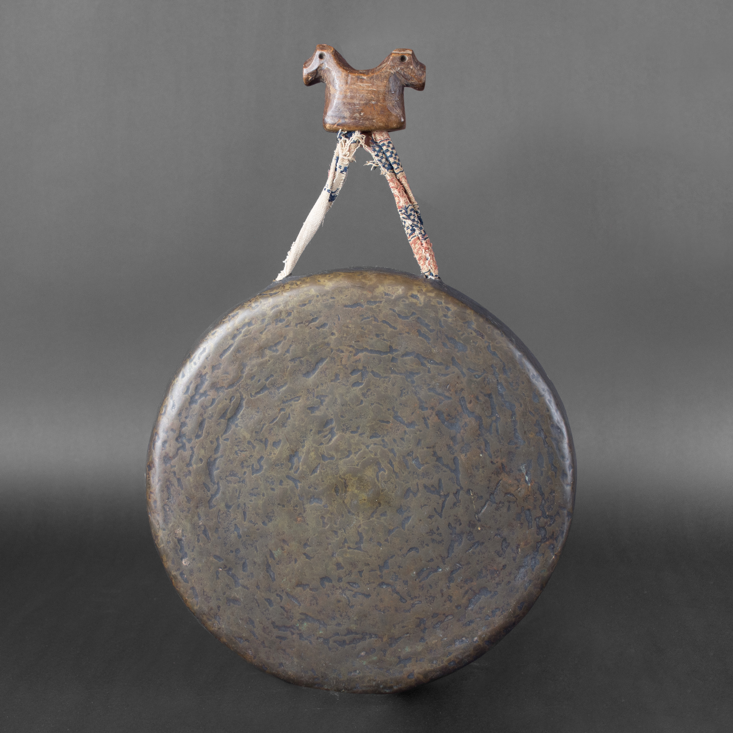 - A rare Ifugao brass Gong with attached old wooden gong handle