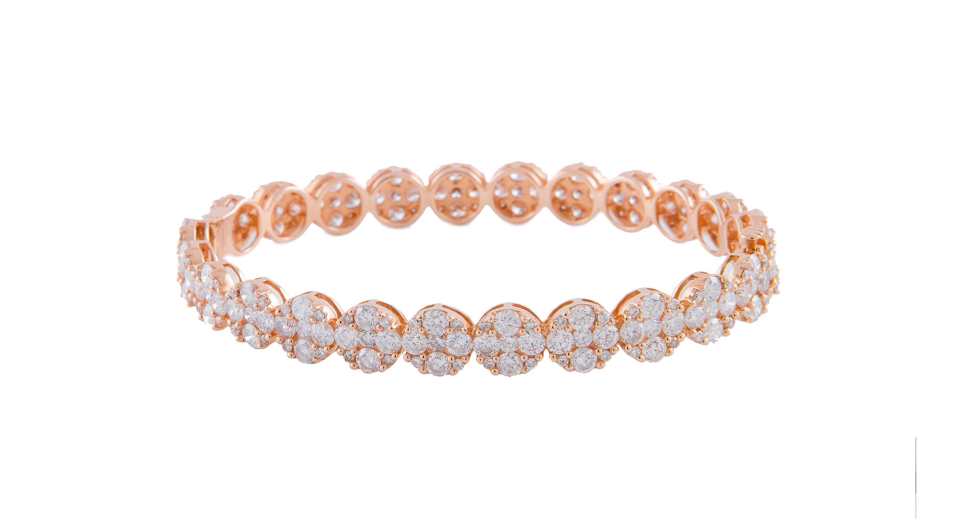 A diamond encrusted rosette bangle, set in rose gold. The flowers are covered with 216 pave ...