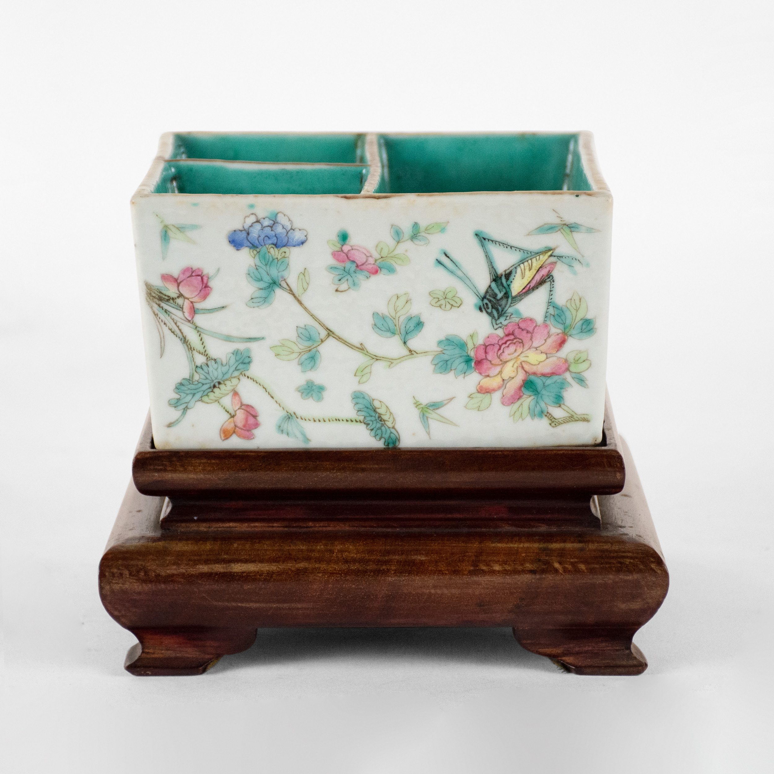 - A square ceramic container with a wooden stand